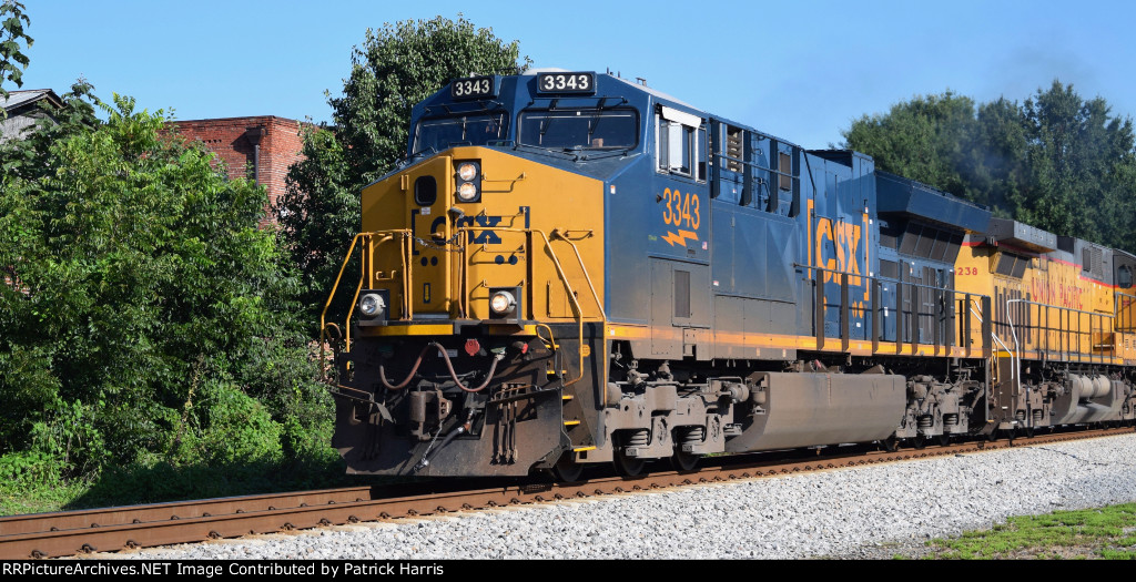 CSX 3343 ET44AH leads UP 6238 X-SP 185 AC44CW with two more UP motors and 180 cars south through ...
